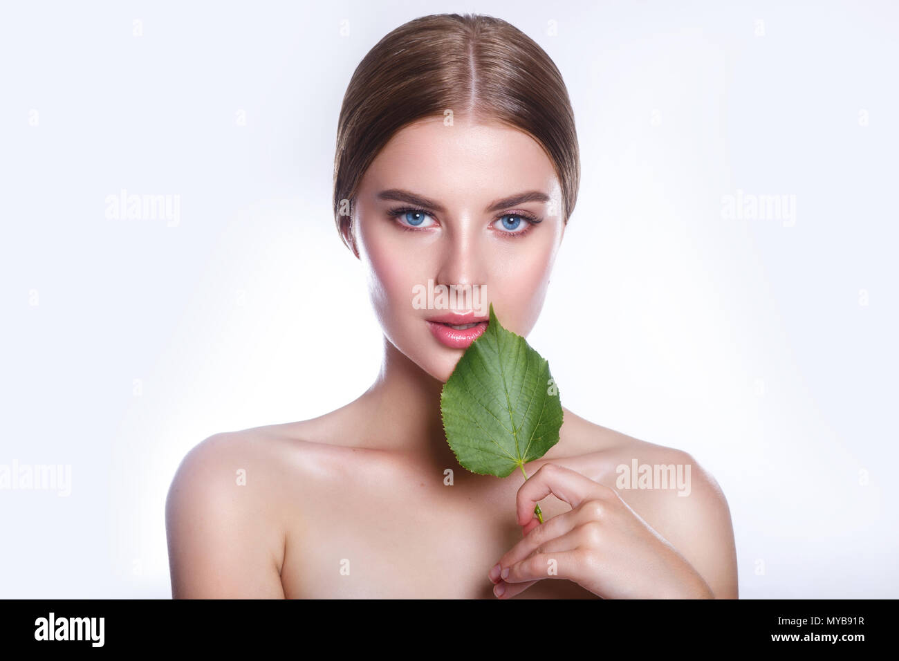 Beautiful Woman Face Portrait With Green Leaf Concept For Skin Care Or