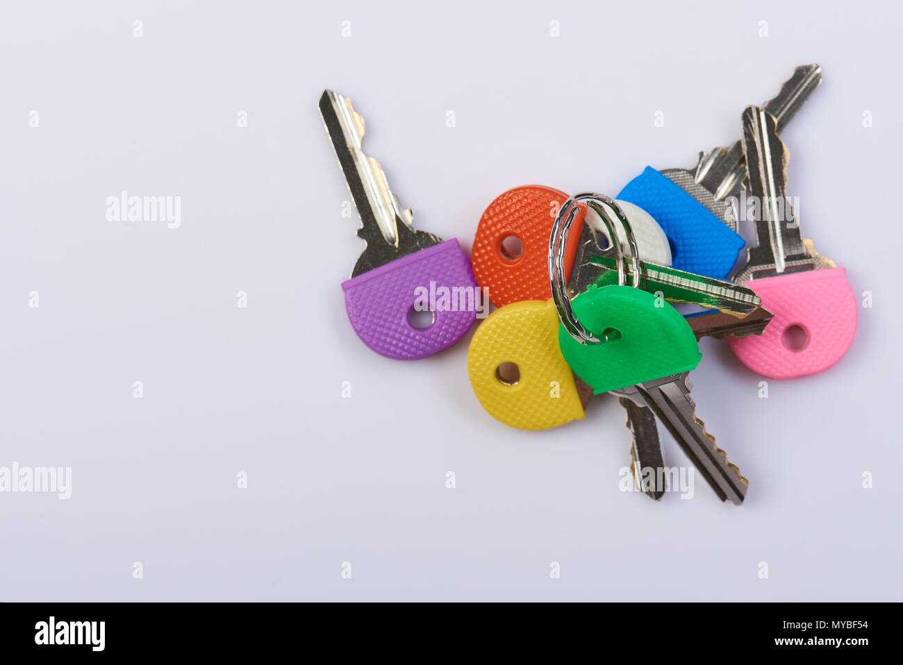 Pile of colorful keys isolated on white background Stock Photo - Alamy