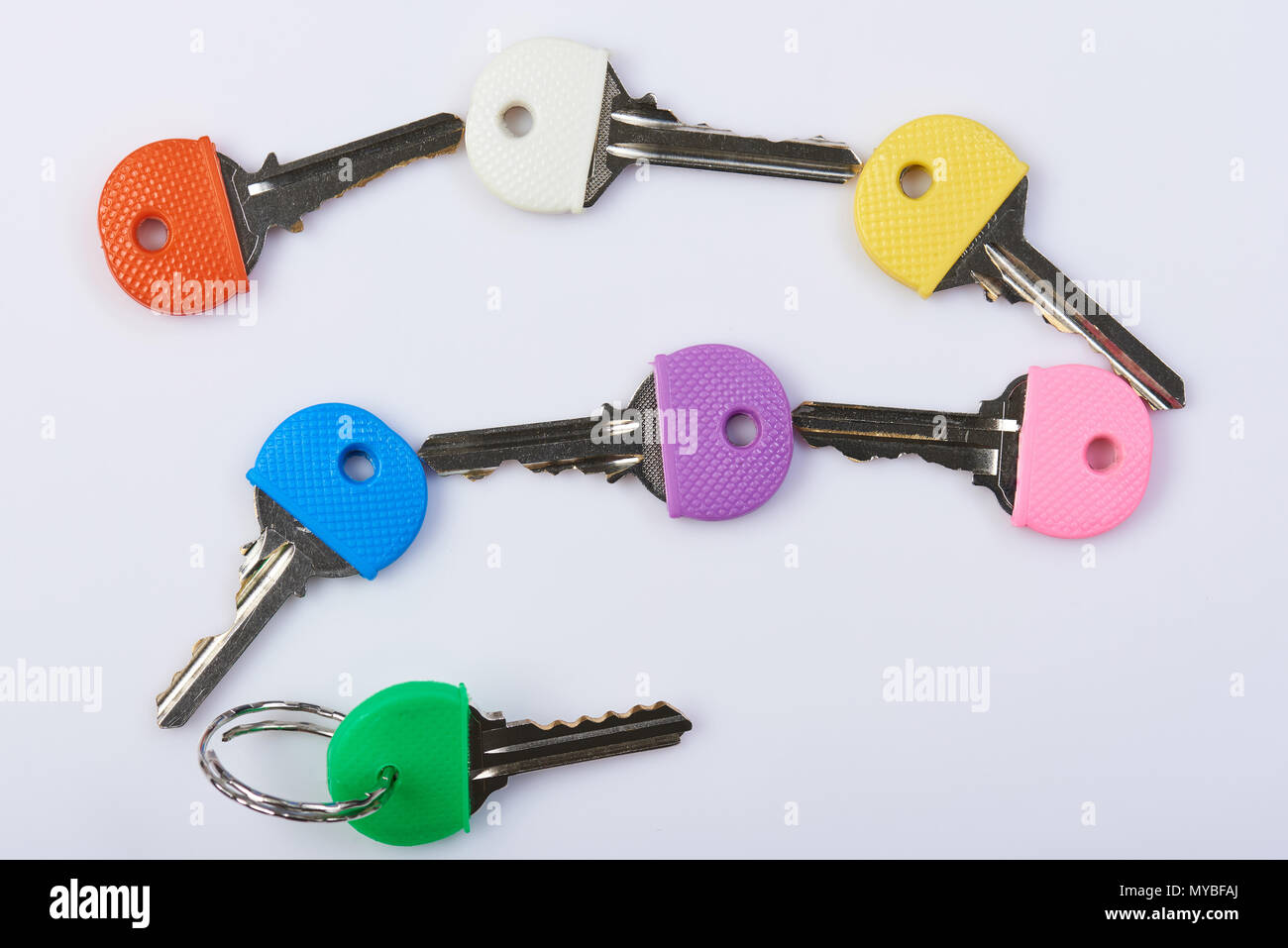 Line of colorful keys lay isolated on white background Stock Photo - Alamy