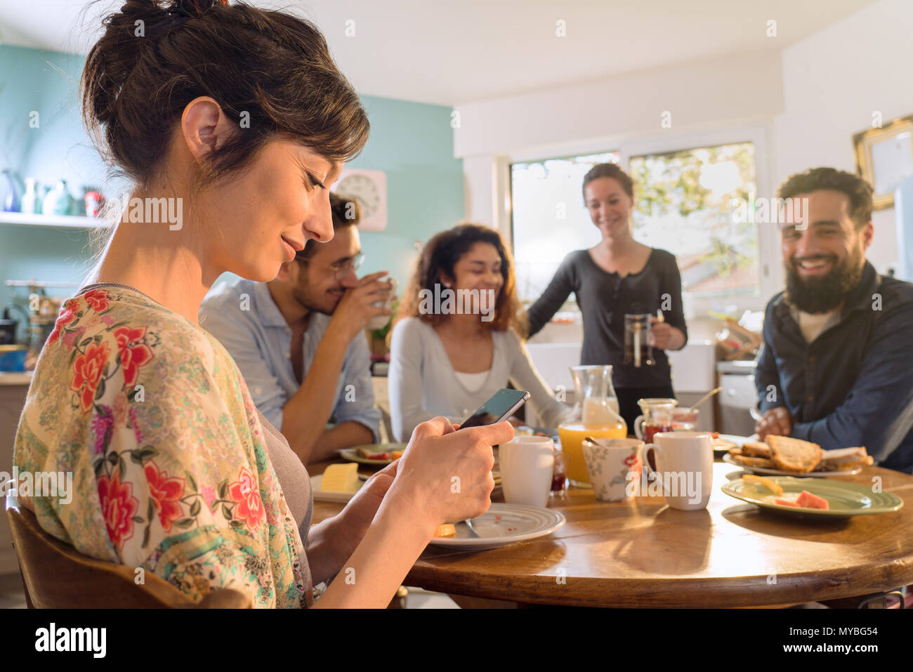 A multi ethnic group of people around a table hi-res stock photography ...