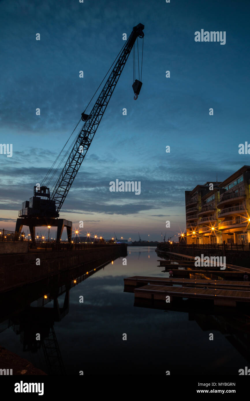 Cardiff Bay's architecture with crane silhouetted against the sky as ...