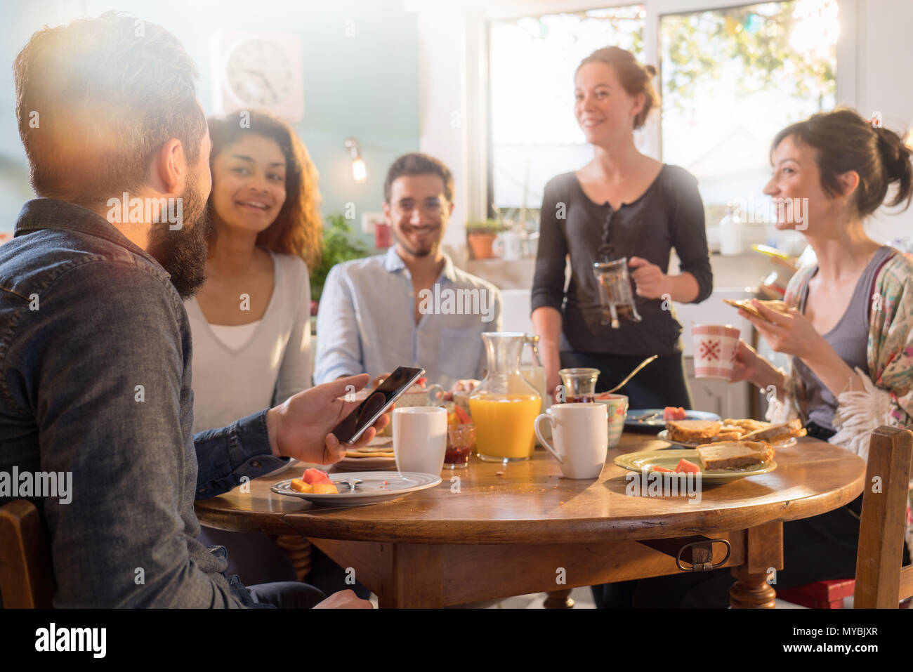Group friends gathered around table hi-res stock photography and images ...