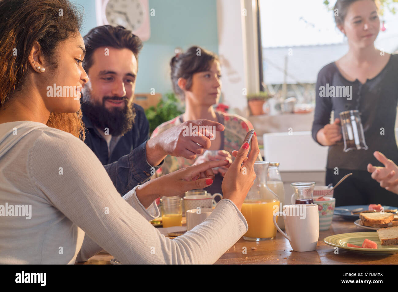 A multi ethnic group of people around a table hi-res stock photography ...