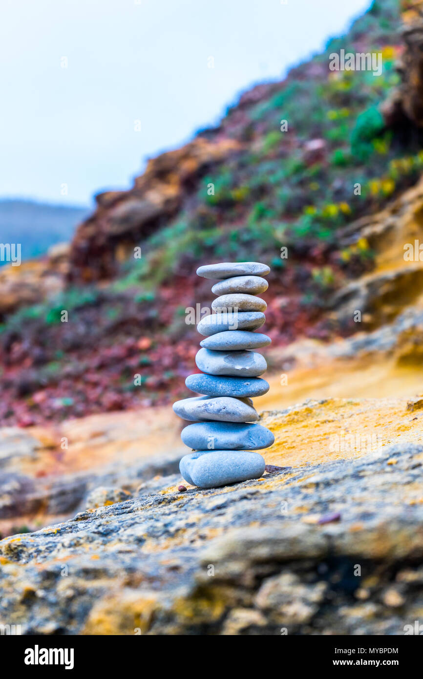 Thin stones stapled on top of each other creating a zen-like figure ...