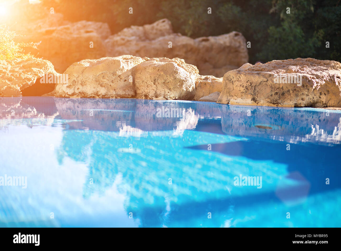 Outdoor inground residential swimming pool in backyard with hot tub ...