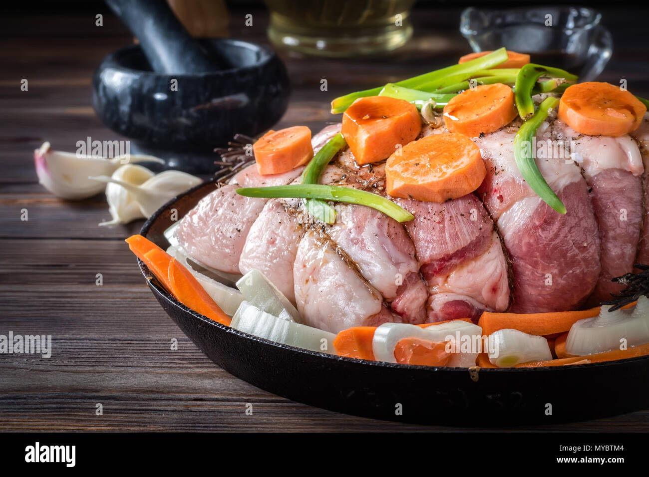 Raw pork chop marinated meat roll wrapped with twine made of jute, with ...