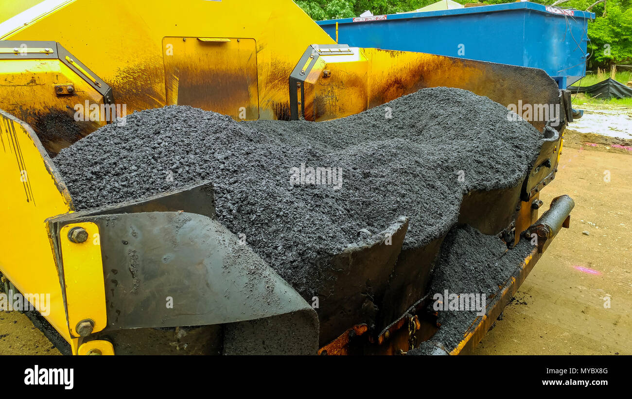 Asphalting paver machine during Road street repairing works machinery ...