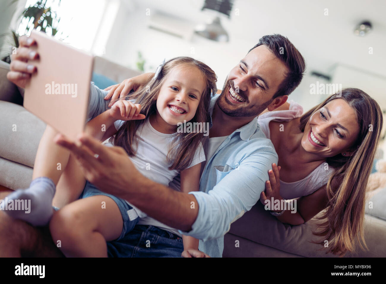 Happy family having fun time at home Stock Photo - Alamy