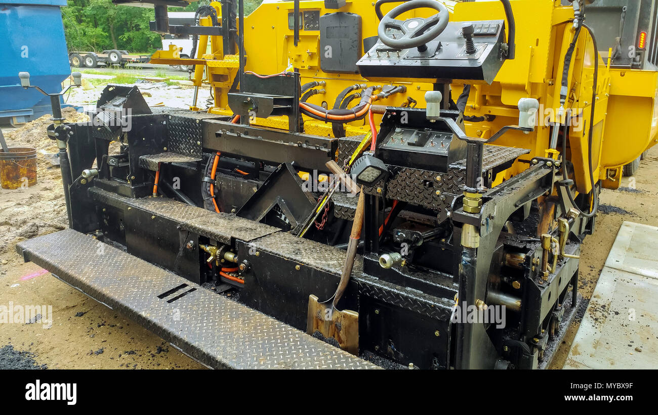 Asphalt spreading machine. Road construction. Applying new asphalt ...