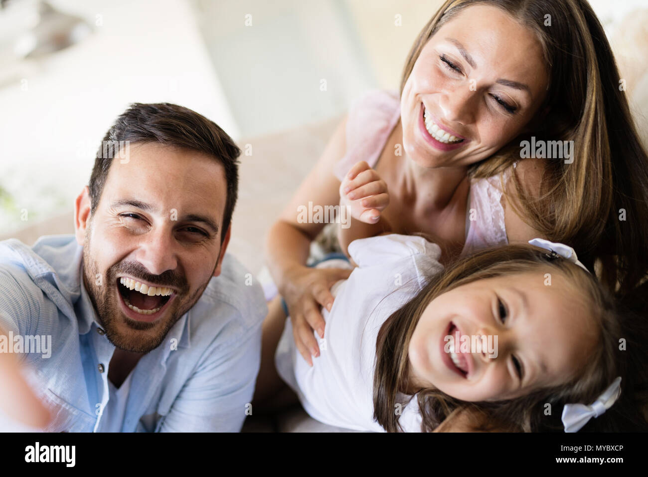 Happy family having fun time at home Stock Photo - Alamy
