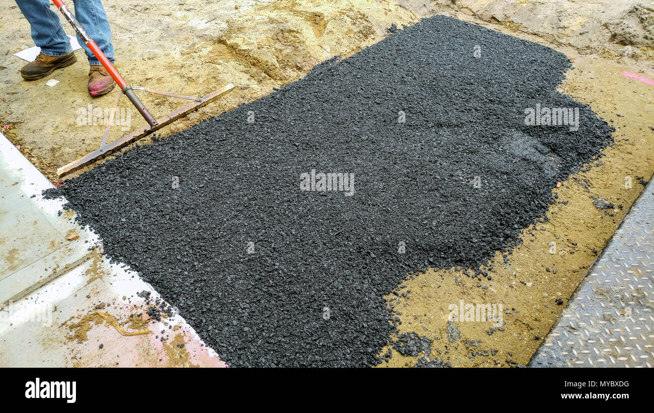 Applying new hot asphalt using road construction Workers on Asphalting ...