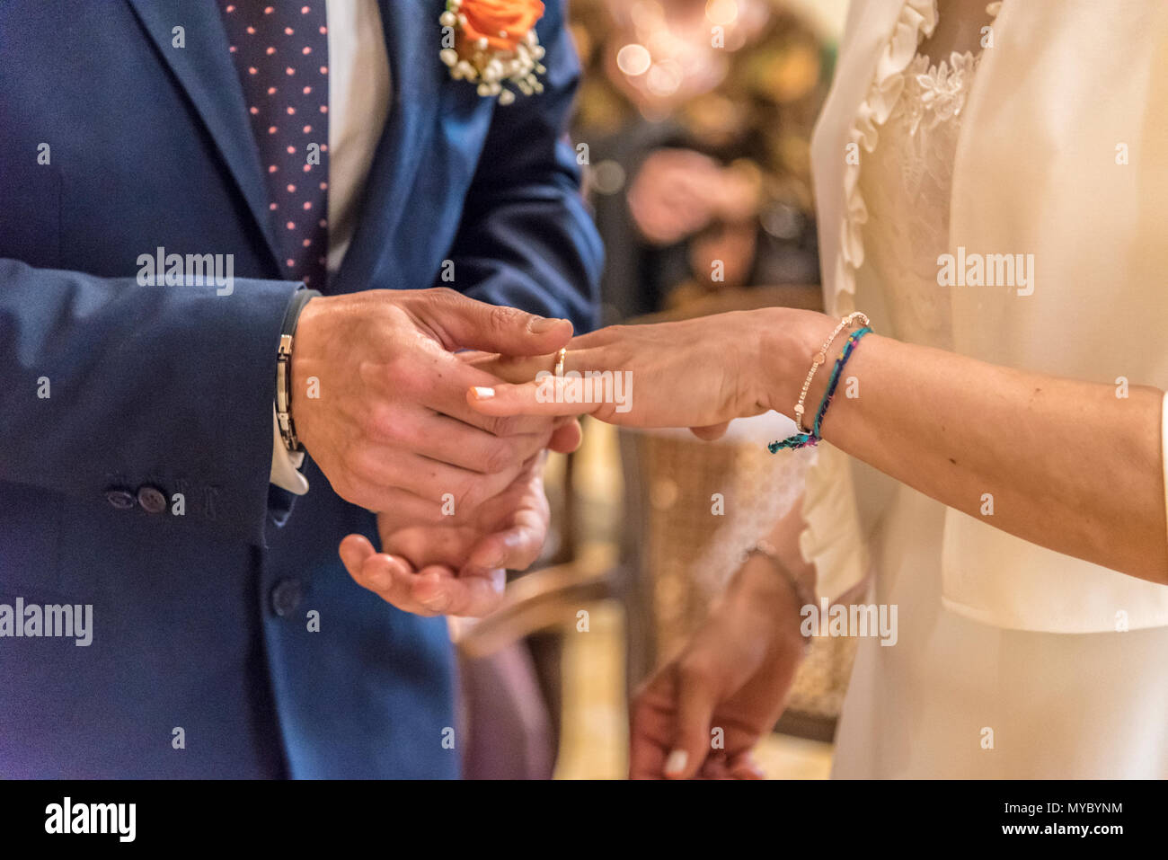 Groom putting a ring on bride's finger during wedding ceremony Stock ...