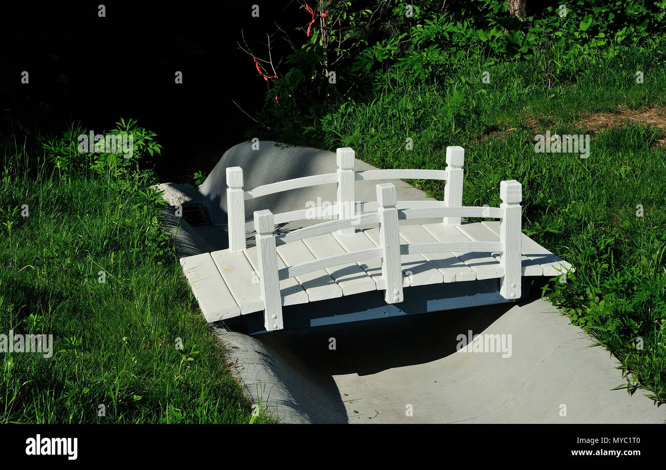 Small footbridge across drainage channel Stock Photo - Alamy