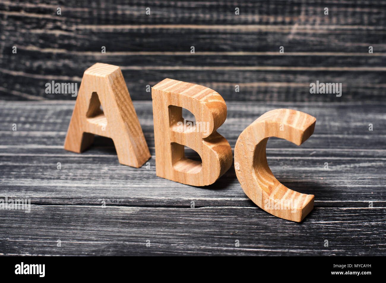 Alphabet made of wood on the background of a board, ebony. Concept of ...