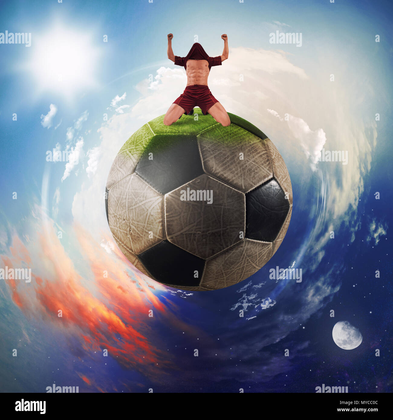 Football player exults in a soccer ball planet Stock Photo - Alamy