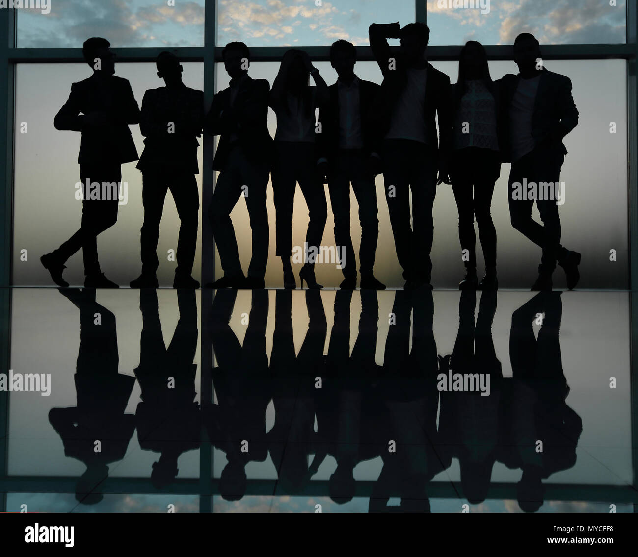 silhouette of a business team standing next to the office window Stock ...