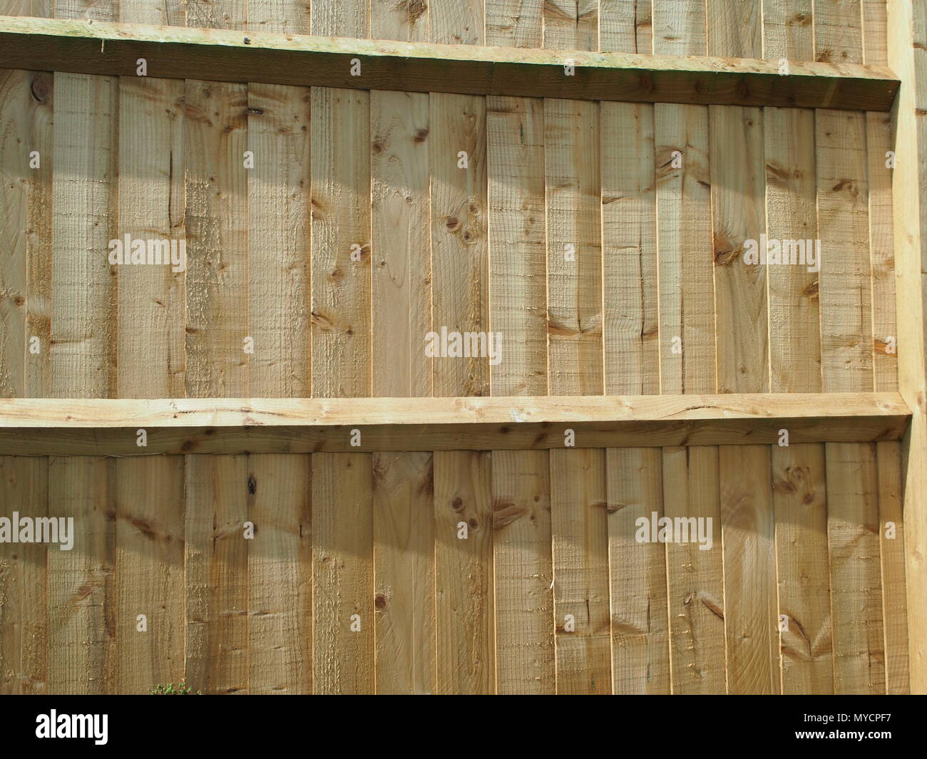 Back view of close boarded fence showing Arris rails and fencepost ...