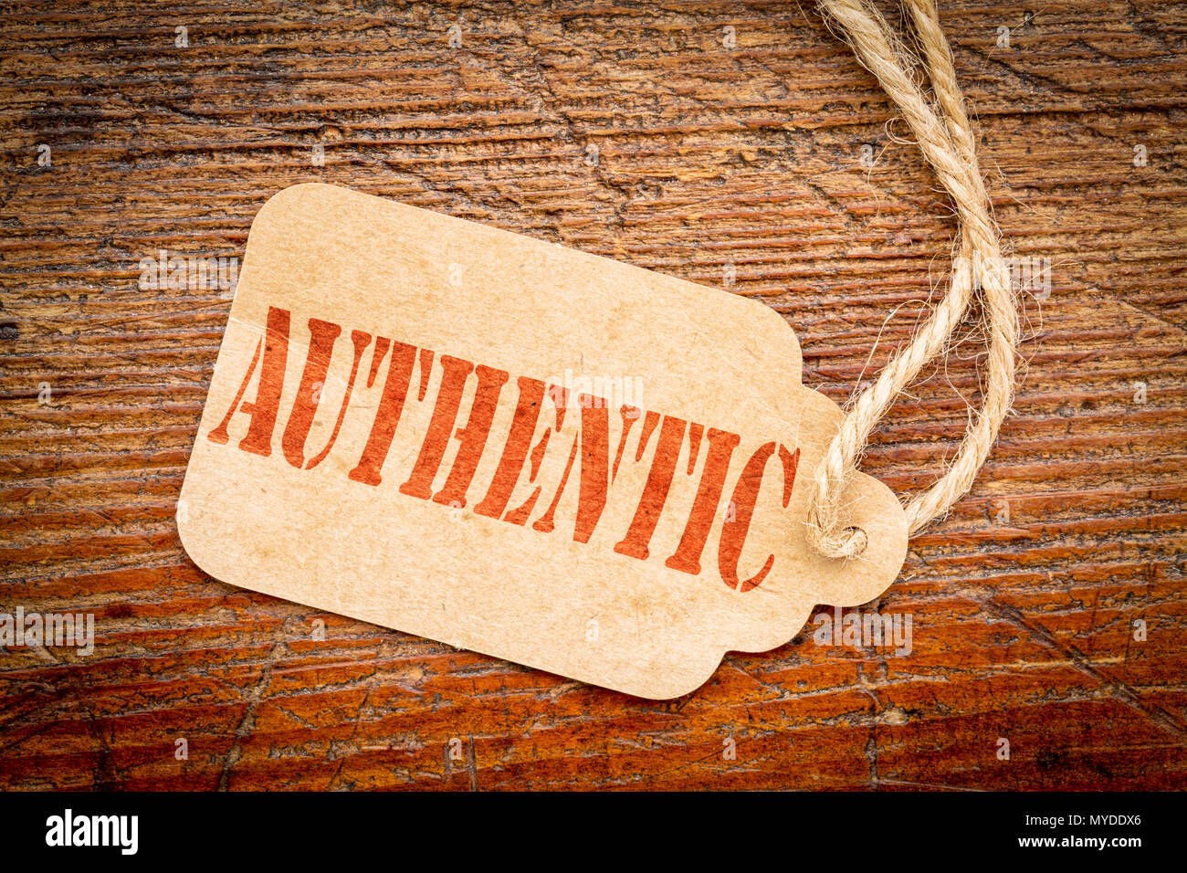 Authentic sign - red stencil text on a cardboard price tag against ...