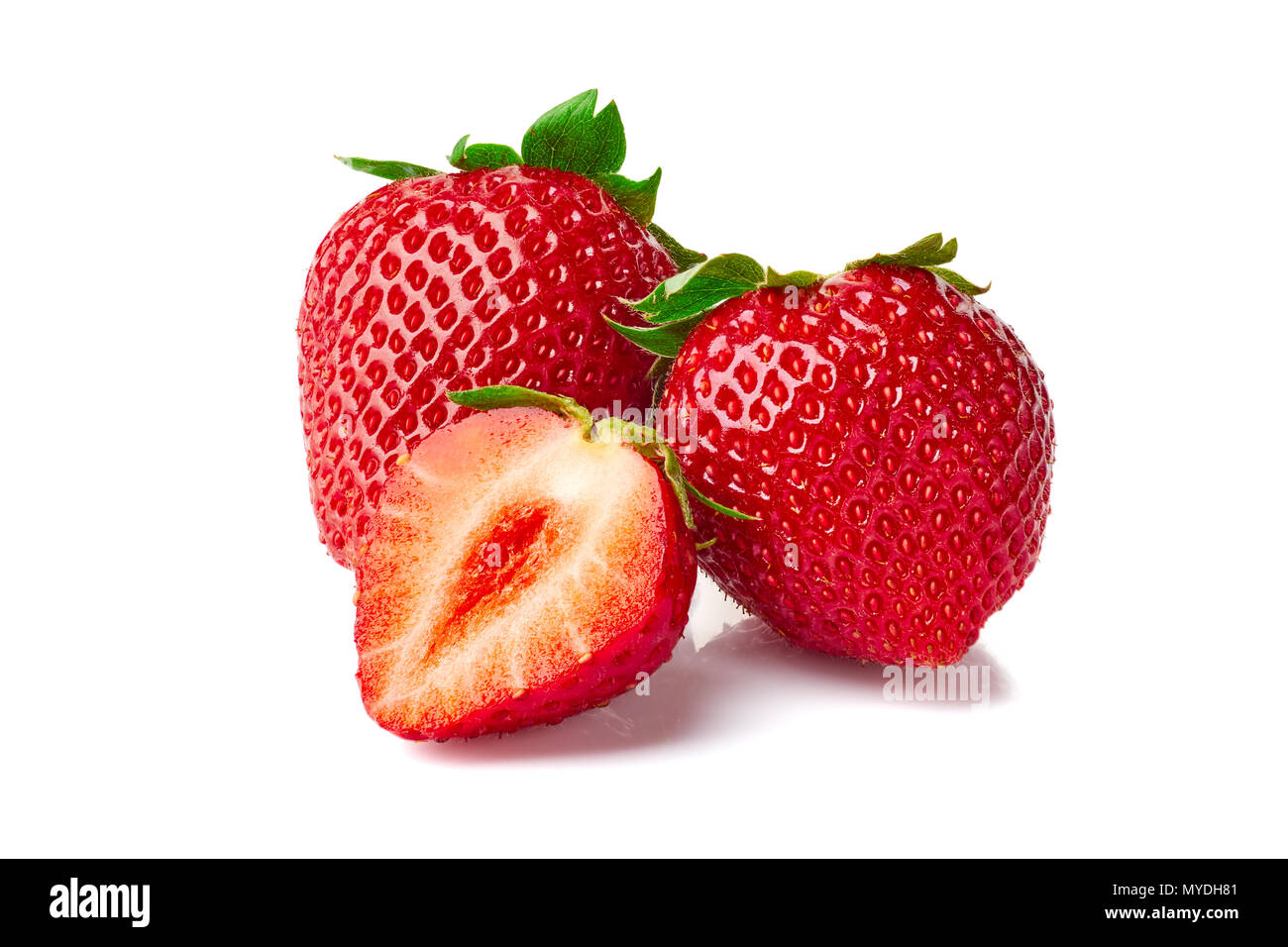 Two entire and half strawberry on white Stock Photo - Alamy