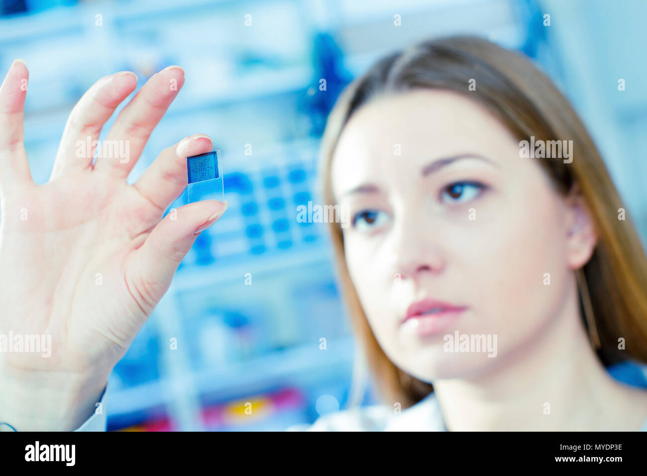 Technician examining microchip in microelectronics laboratory Stock ...