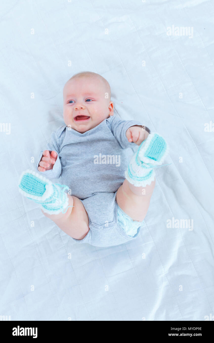 Baby boy lying on back Stock Photo - Alamy