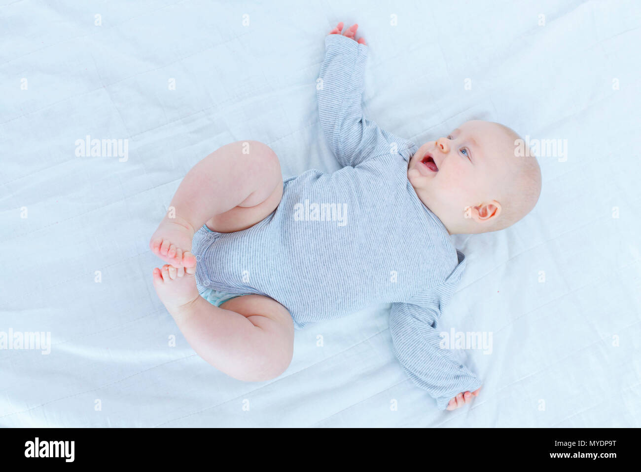 Baby boy lying on back Stock Photo - Alamy