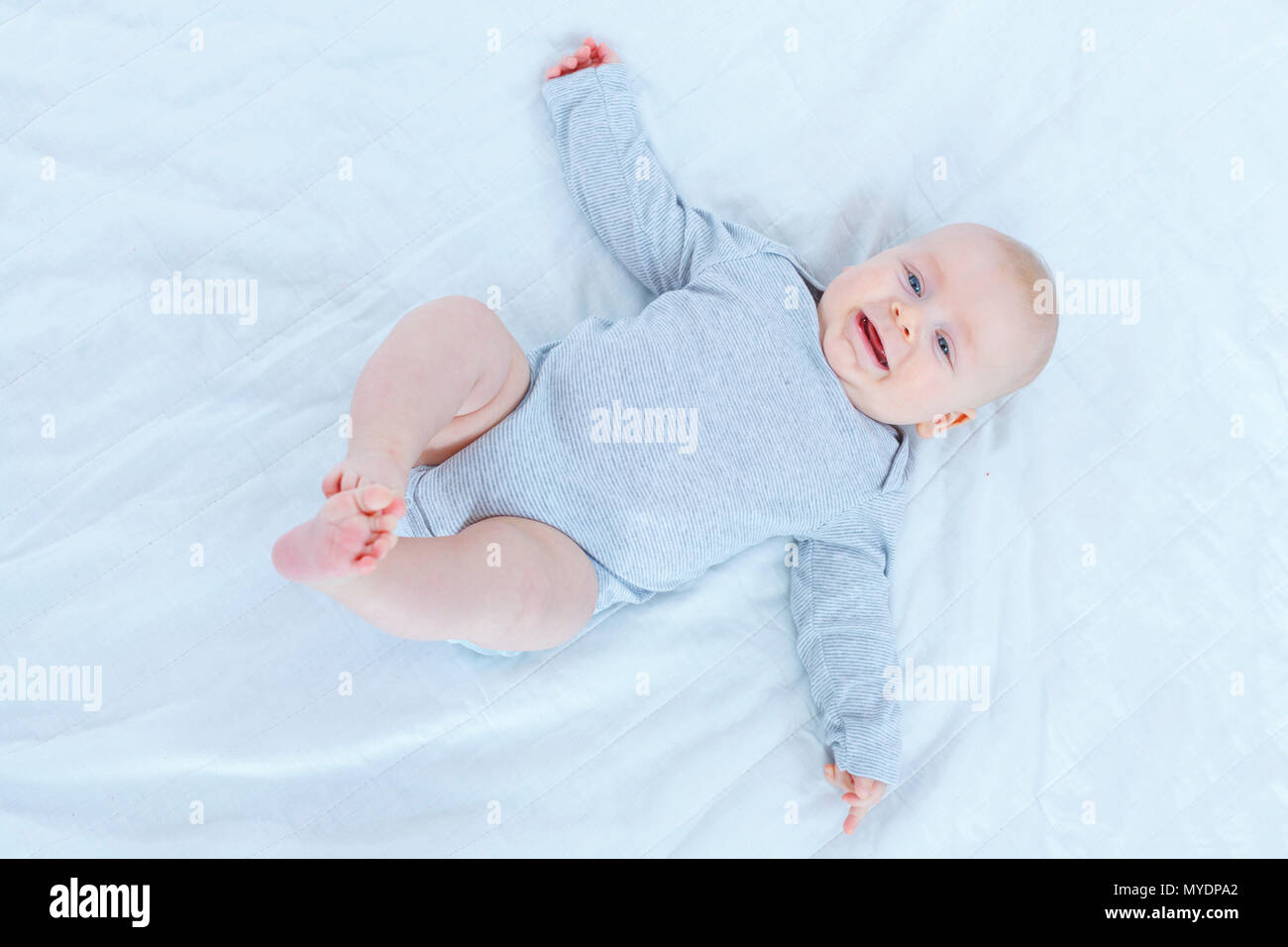 Baby boy lying on back Stock Photo - Alamy