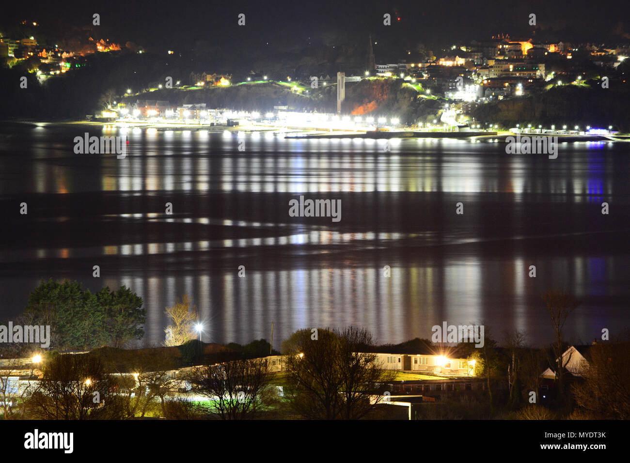 Illuminated Shanklin Seafront creating reflections from the calm sea of ...