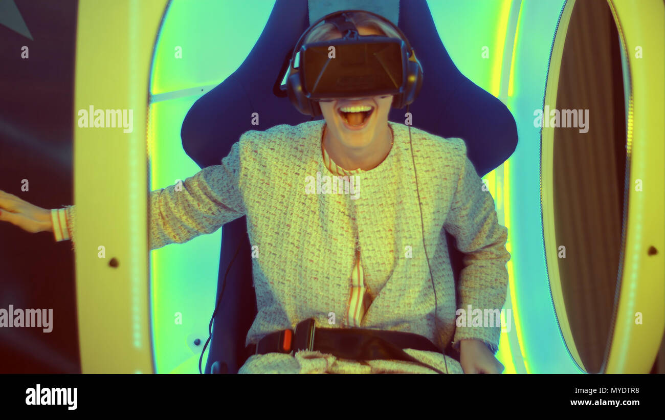 Surprised young female experiencing virtual reality for the first time ...