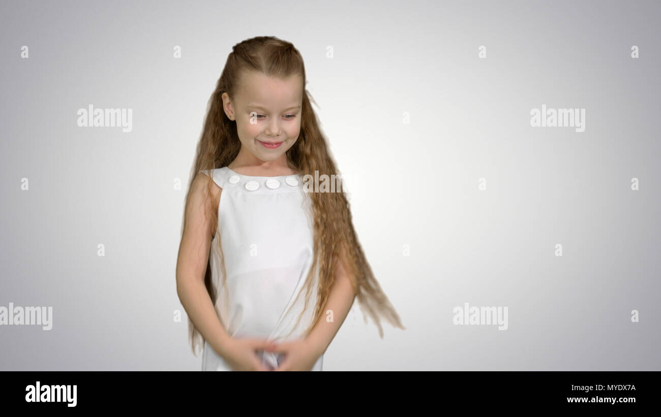 Little girl singing and dancing on white background Stock Photo - Alamy