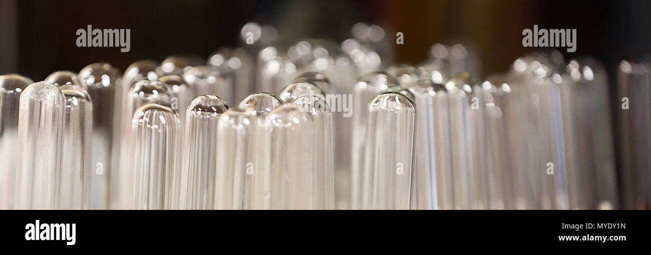 close up of multiple many glass test tubes upside down making a bright ...