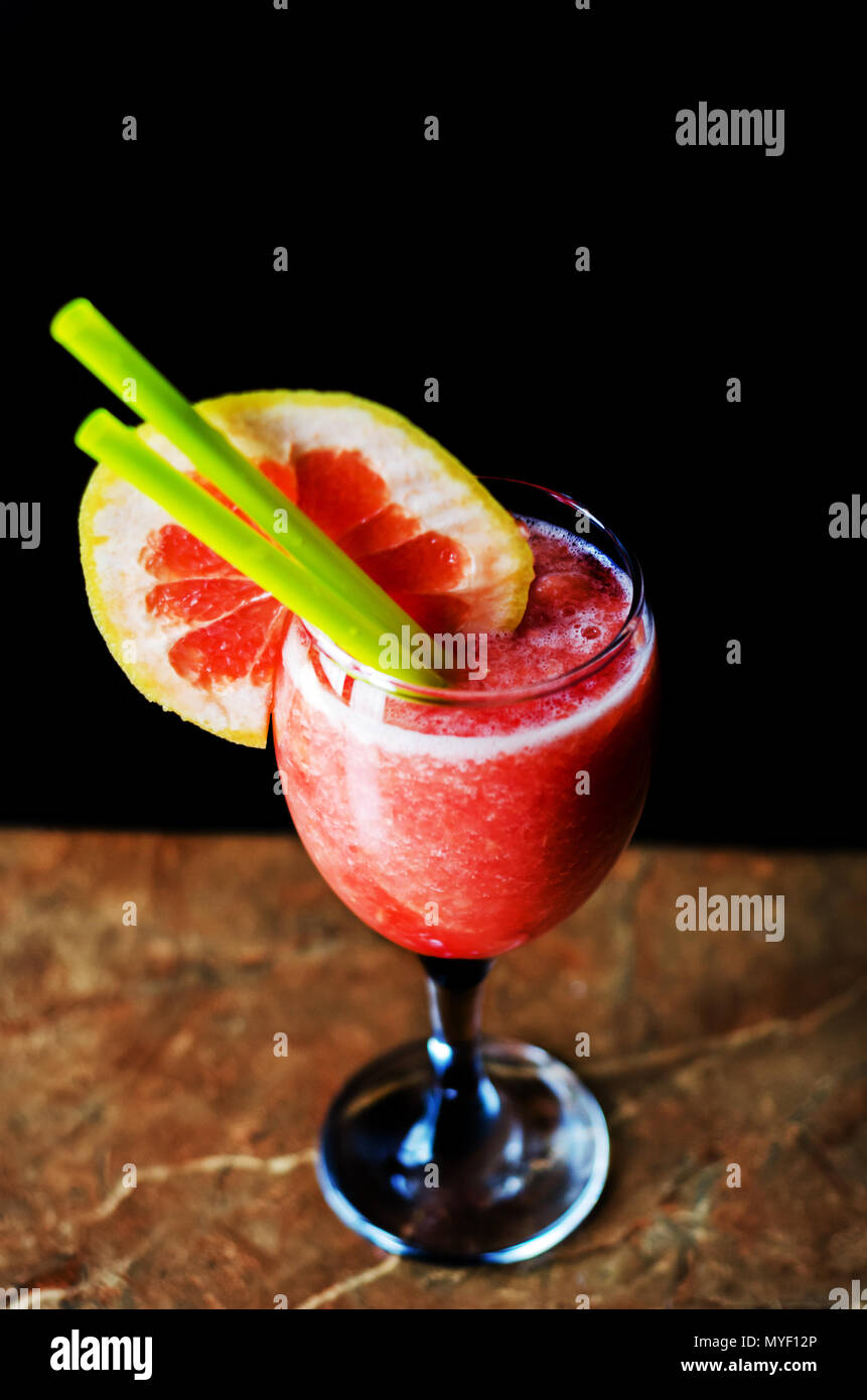 healthy smoothie with ripe pomelo fruit in a glass, a drink decorated ...
