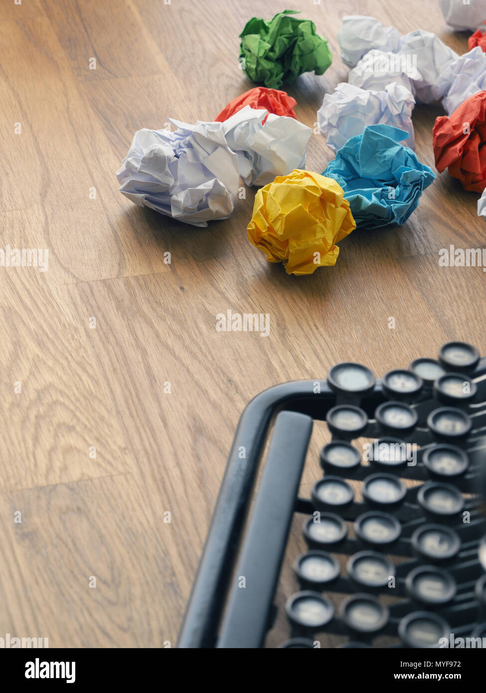 Crumpled paper with an old typewriter on a wooden office table ...