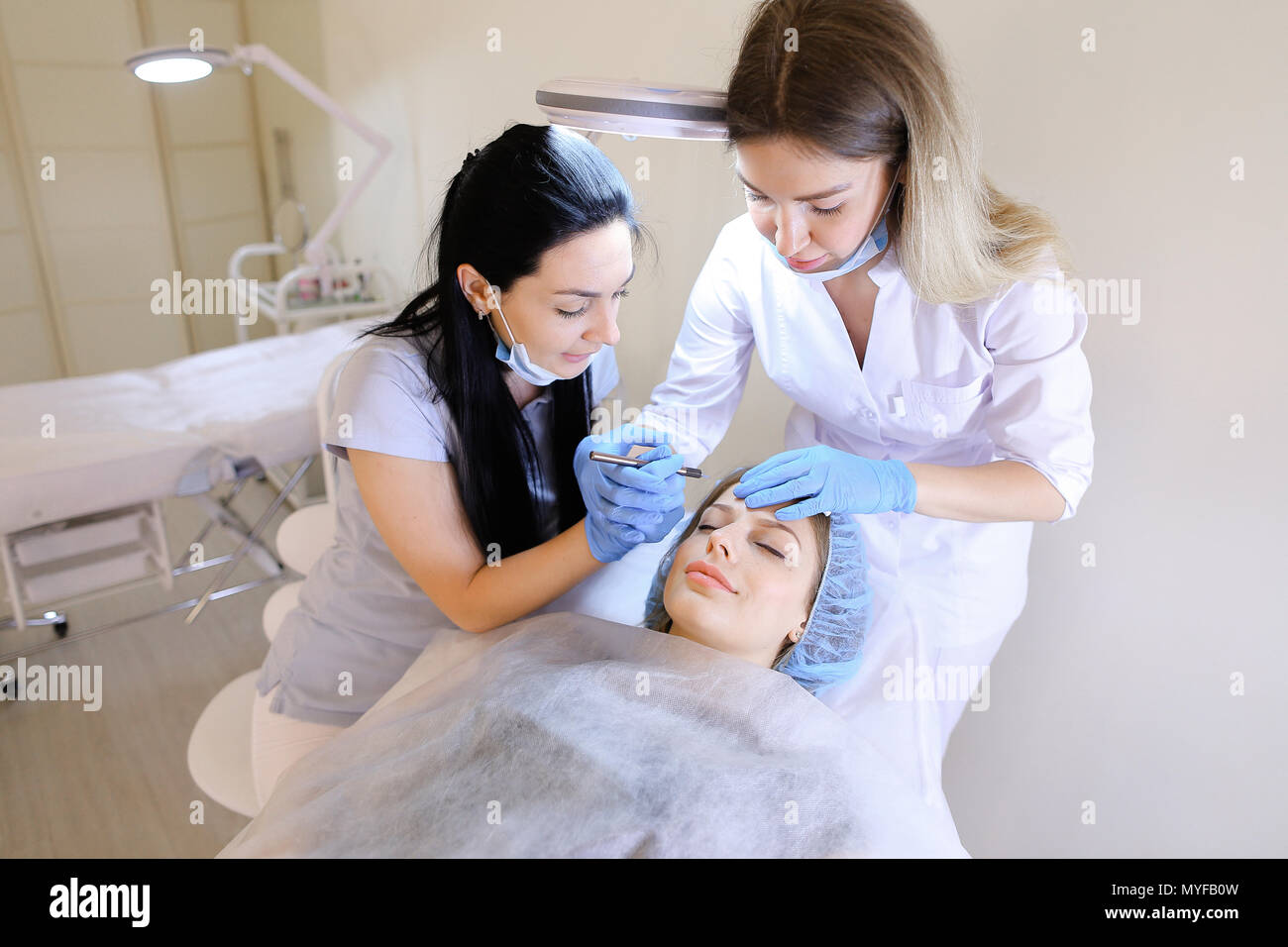 Caucasian woman visiting professional dermatologist and cosmetologist ...