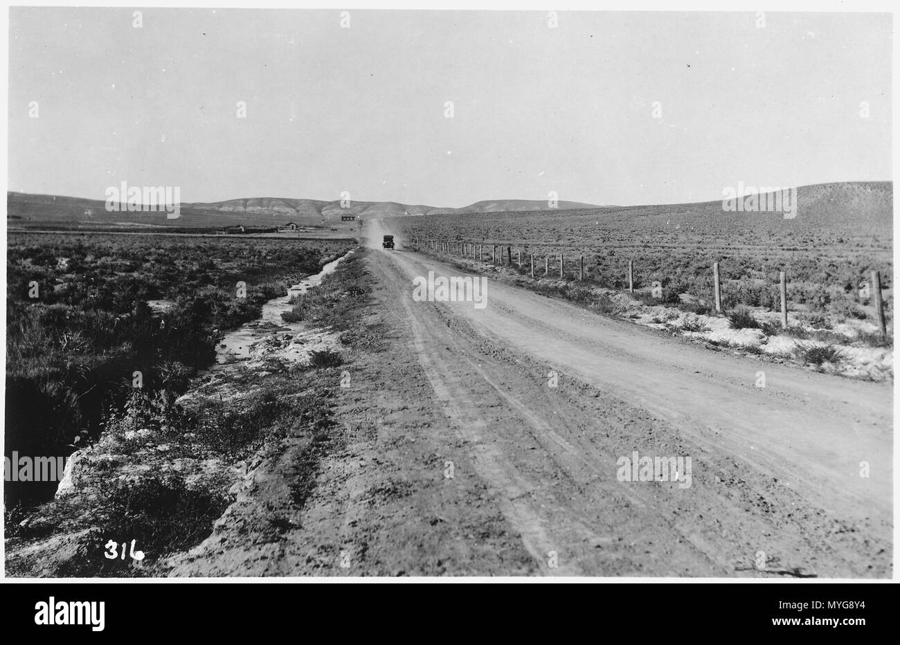 8.4 miles from Lander, showing section of road over low level Stock ...