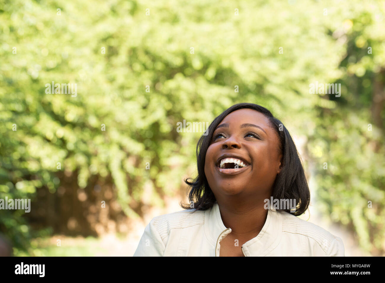 Portrait of a happy African American woman smiling outside Stock Photo ...