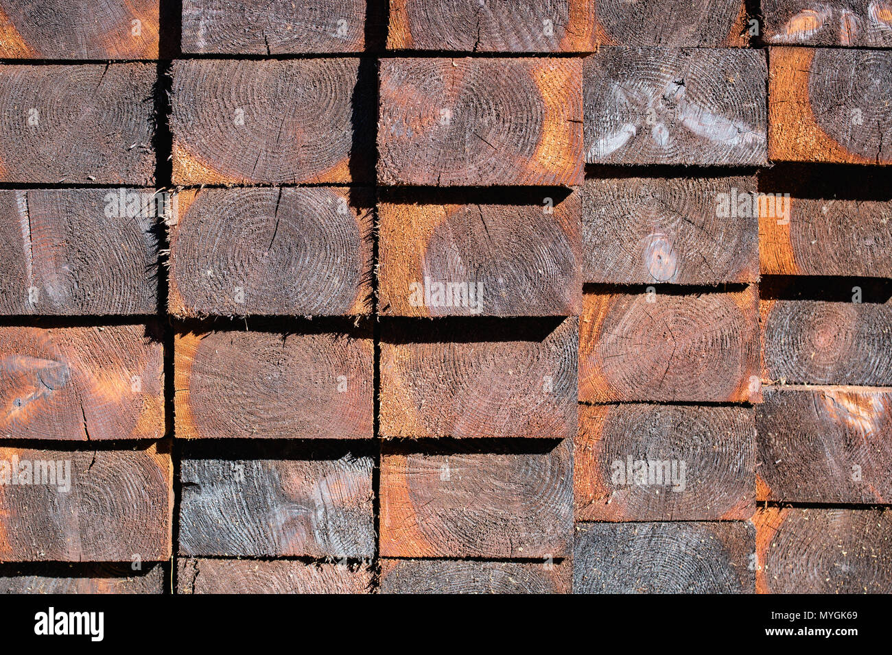 Stack of railway beams, track underlays, old wooden balks, wood tar ...