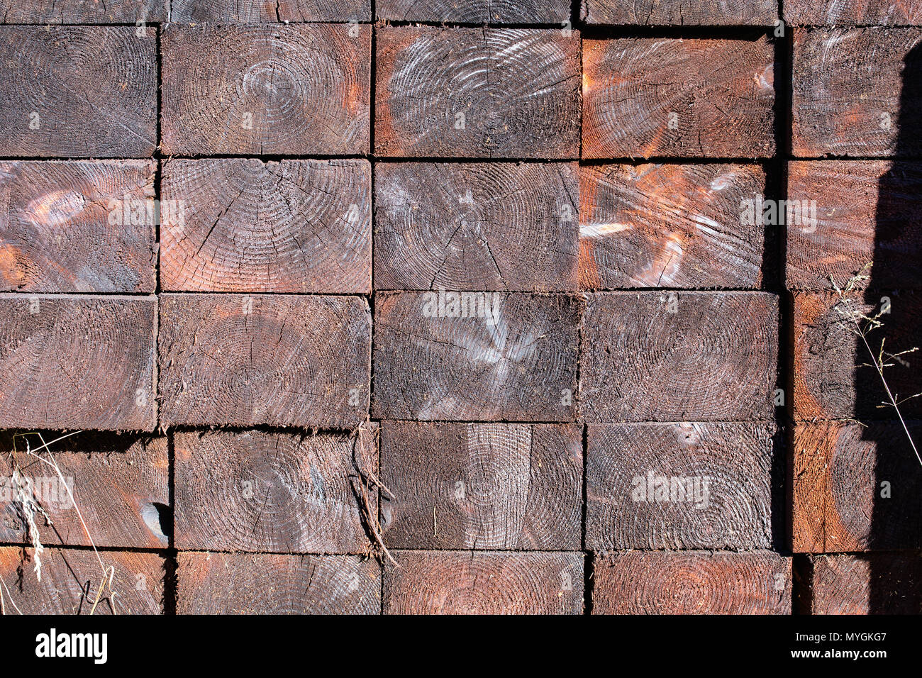 Stack of railway beams, track underlays, old wooden balks, wood tar ...