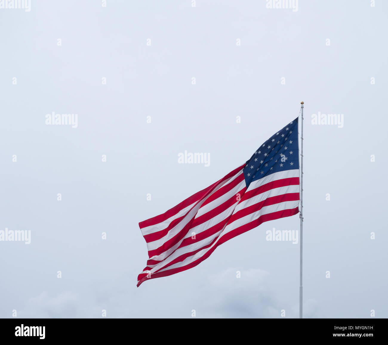 American flag blowing in breeze hi-res stock photography and images - Alamy