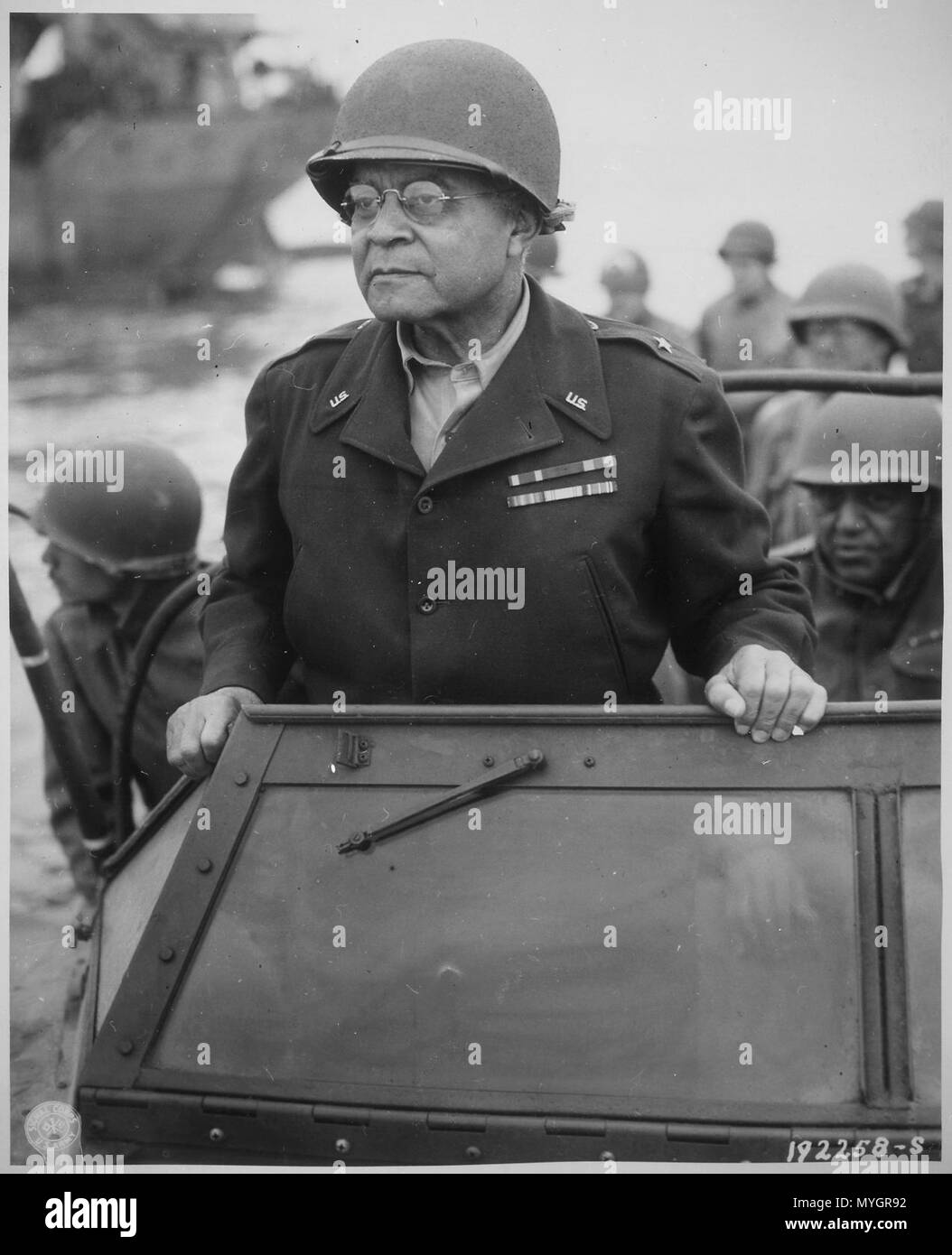Brig. Gen. Benjamin O. Davis watches a Signal Corps crew erecting poles ...