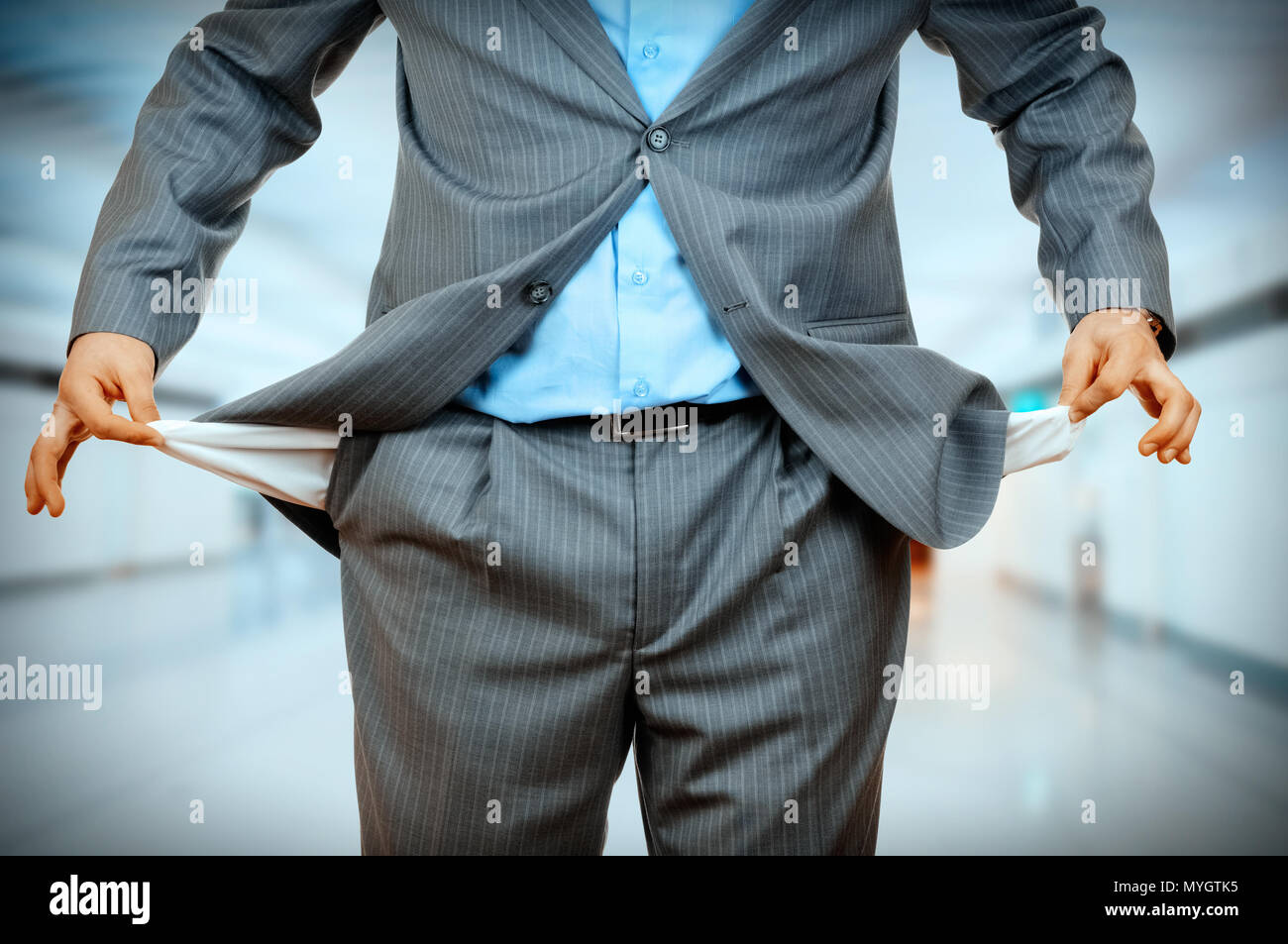 Photo of the man pulling out empty pockets Stock Photo - Alamy