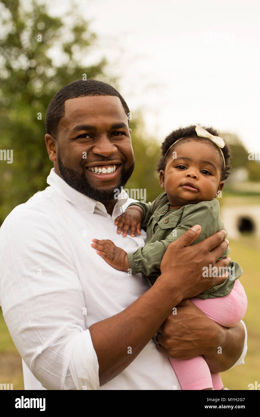 African American loving father holding his daughter Stock Photo - Alamy