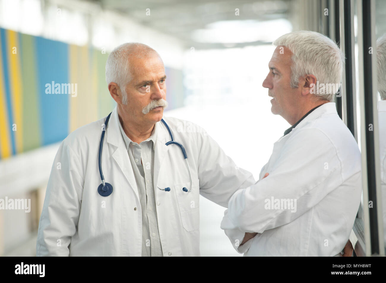 two male doctors having a conversation Stock Photo - Alamy