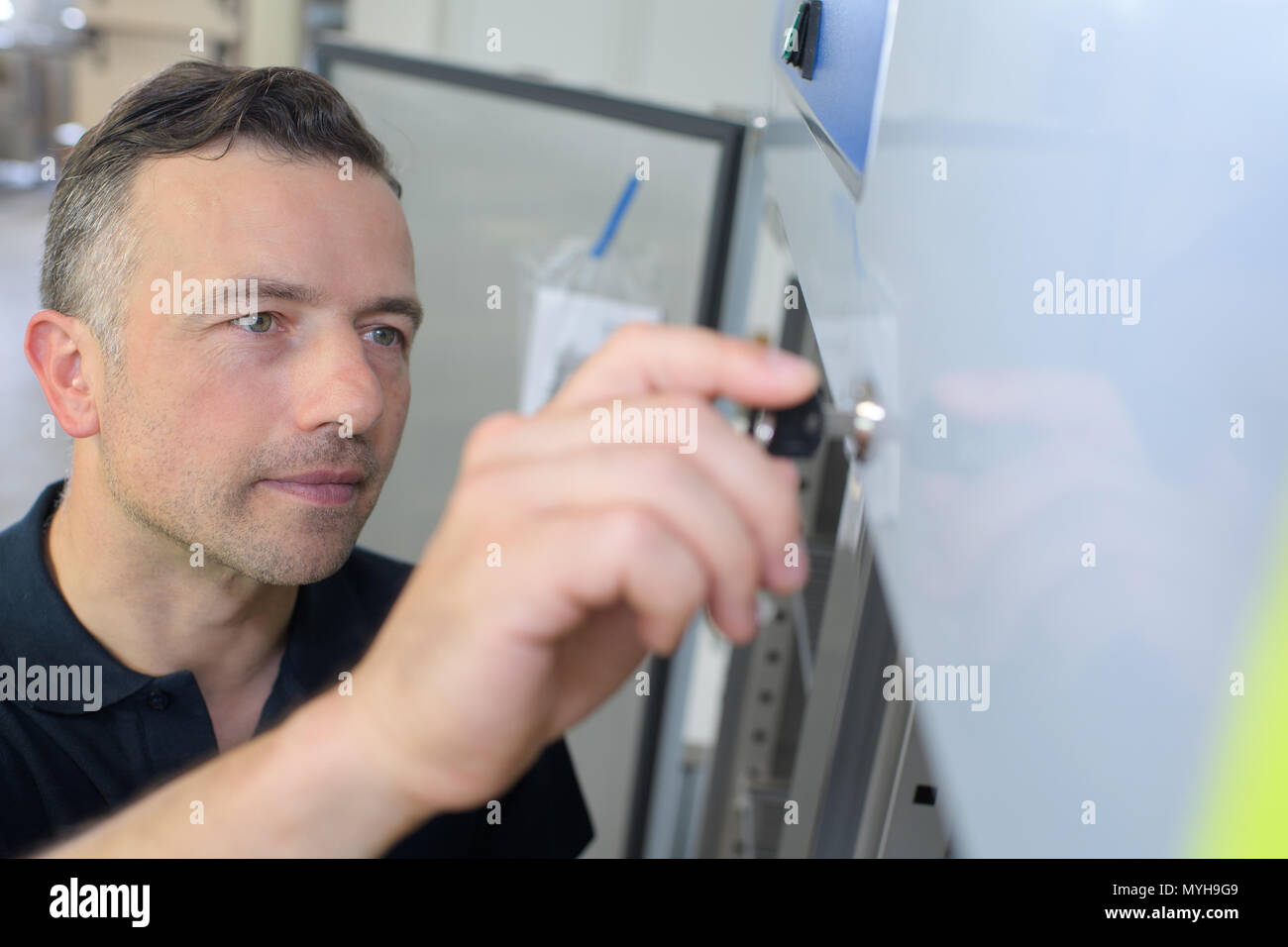 worker fixing the machine Stock Photo - Alamy