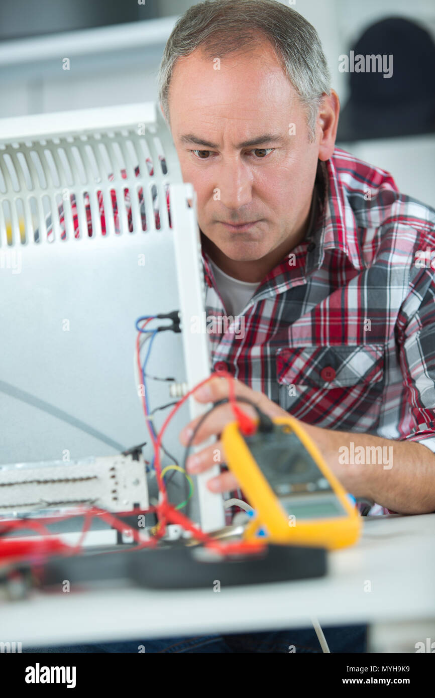 portrait of man fixing radiator Stock Photo - Alamy