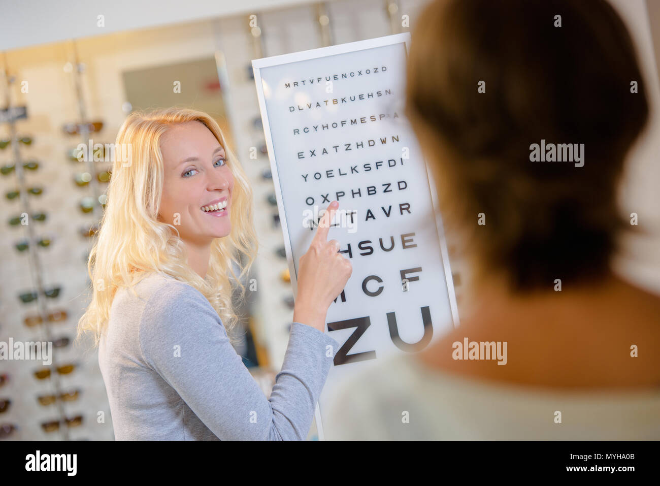 Woman reading eye chart hi-res stock photography and images - Alamy