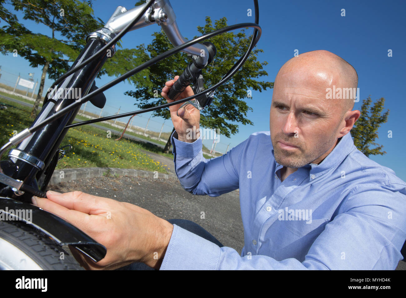 Male cyclist repairing mountain bike hi-res stock photography and ...