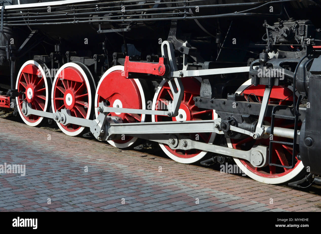 Wheels of the old black steam locomotive of Soviet times. The side of ...