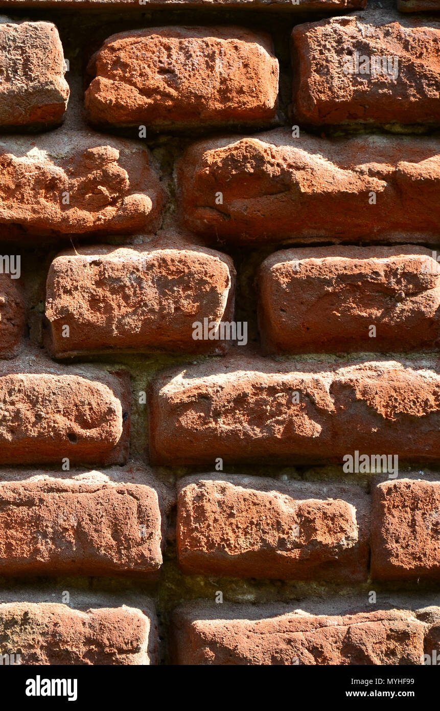 Vertical wall texture of several rows of very old brickwork made of red ...