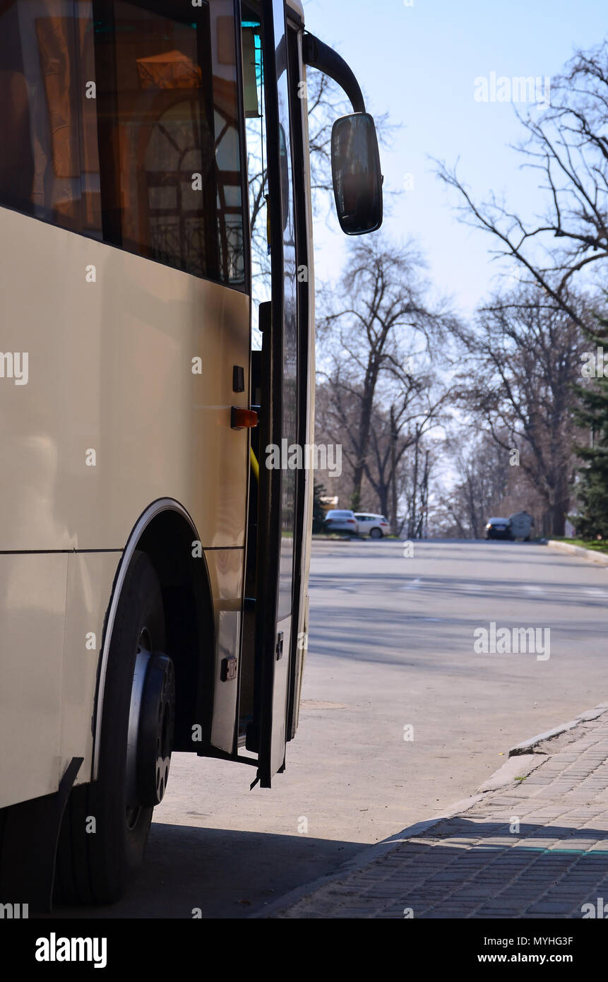 Photo of the hull of a large and long yellow bus. Close-up front view ...